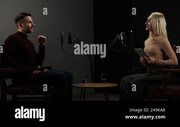 Online podcast show. Man host and woman guest recording interview in ...