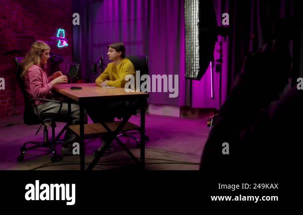 Online podcast. Backstage shot of man host and woman guest recording ...