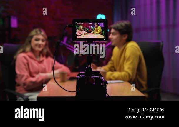 Online podcast. Man host and woman guest recording interview in loft ...