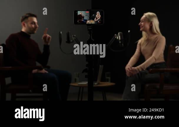 Online podcast show. Man host and woman guest recording interview in ...