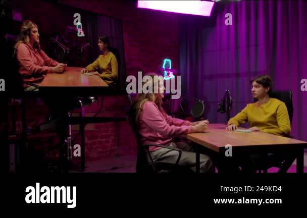 Online podcast. Backstage shot of host and guest recording interview in ...