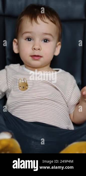 Little baby boss sitting comfortably in the black leather chair. Lovely ...