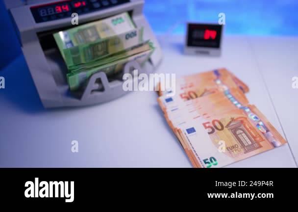 Orange fifty euro bills are on the desk. One hundred euro banknotes ...