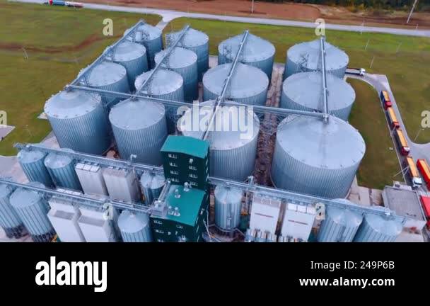 Silo tanks stand in rows connected to each other. Flight above the ...