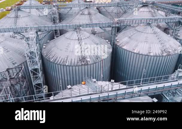 Large metal granary tanks in a group at the territory of agricultural ...