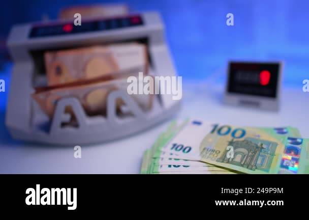 Money counted in bank equipment. Close up. Fifty euro stack in cash ...