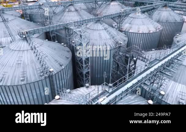 Huge metal granary tanks connected with each other. Aerial perspective ...