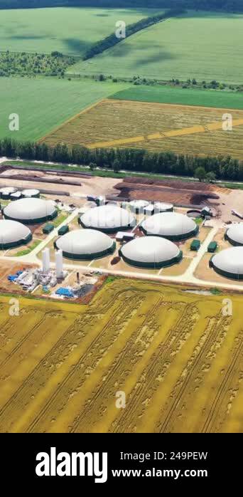Storage tanks for biomass on fields background. Agricultural and ...