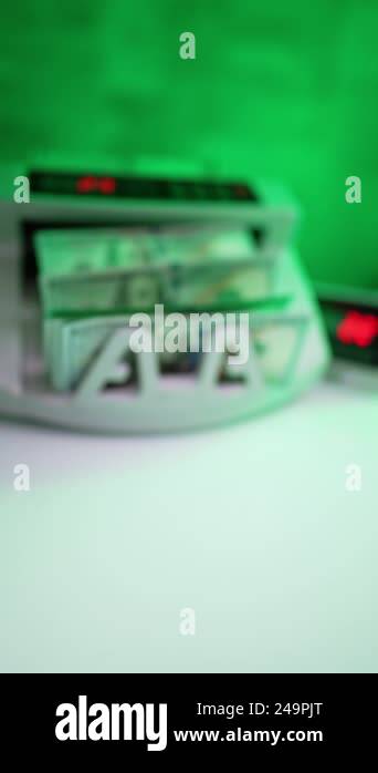 Automatic cash counting machine with one hundred dollar bills. Male ...