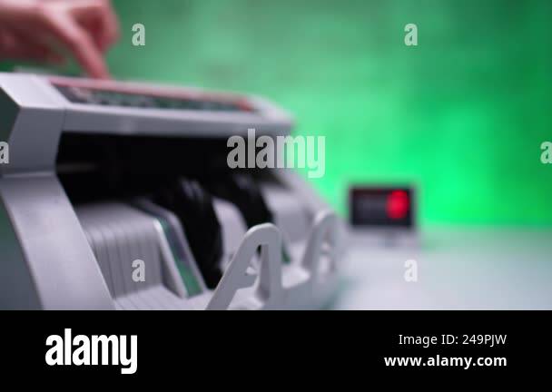 Working cash counting machine with rotating blades. A stack of one ...