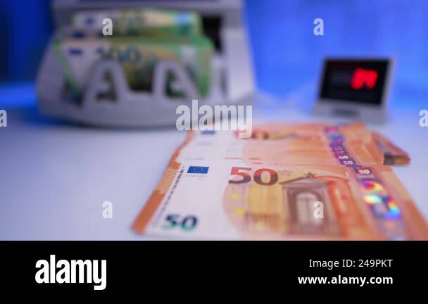 New orange fifty euro banknotes scattered at the foreground. One ...