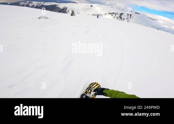 Pov: ride down the picturesque snowy slope of the mountain. Snowboarder ...