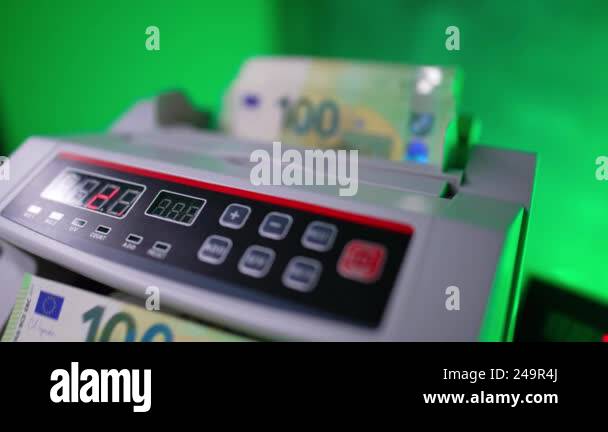 One hundred euro banknotes disappear in cash counting machine. Blades ...