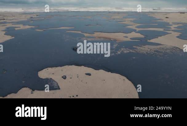 Oil in ocean coastline after a tanker wreck. Oil fuel polluted and ...