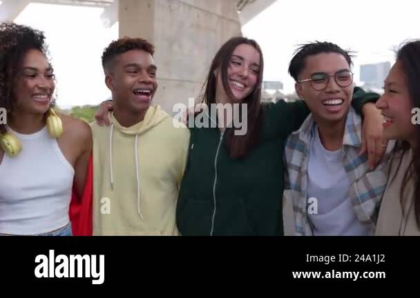 Youth community. Diverse group of happy student friends hugging each ...