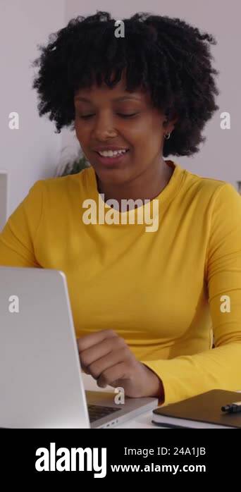 Vertical HD video of young happy student girl taking notes while ...
