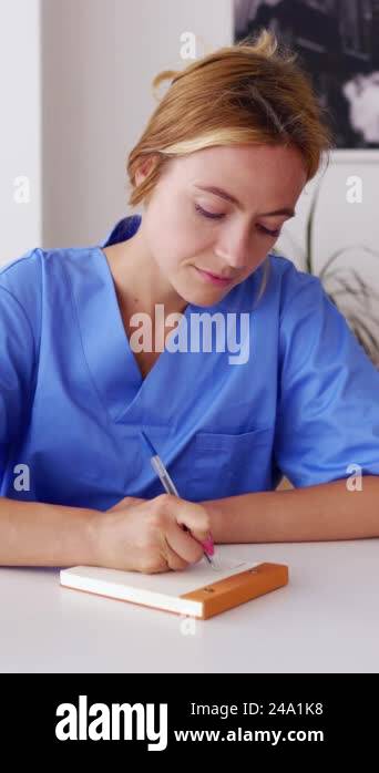 Vertical HD video of beautiful healthcare worker in blue uniform taking ...