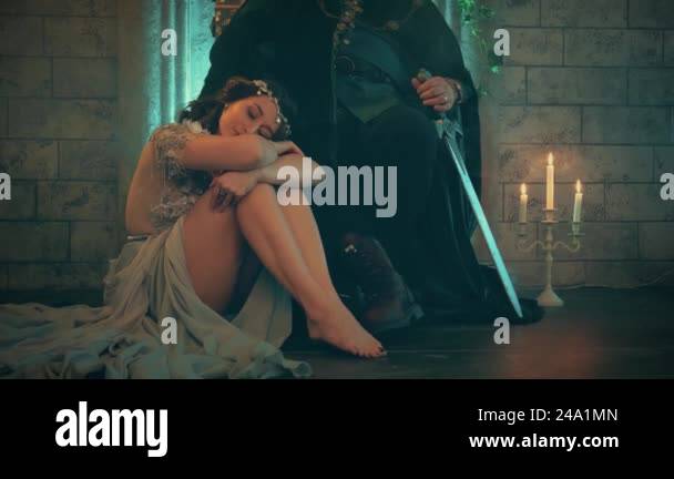 Fantasy couple woman queen sitting in feet medieval dictator king. Man ...