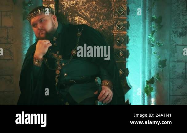 warlike medieval courageous strong man sits on old bronze throne, image ...