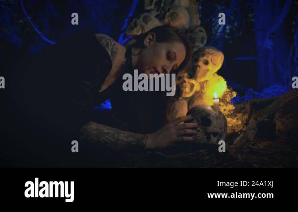 Fantasy horror style portrait mystical adult vampire girl strokes skull ...