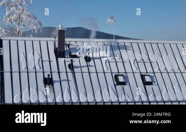 retaining bars against drifting snow falling melting down from tin gray ...