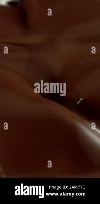Super Slow Motion of Splashing and Mixing Hot Melted Chocolate, Creating Waves Shapes, Filmed on ...