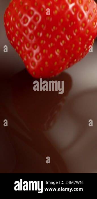 Super Slow Motion of Falling Strawberry into Melted Chocolate. Filmed ...