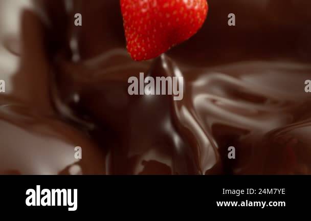 Super Slow Motion of Falling Strawberry into Melted Chocolate. Filmed on High Speed Cinema ...
