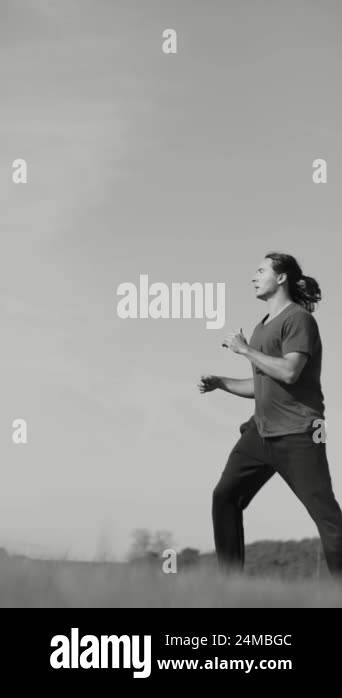 Slow motion. In a stunning natural setting, a skilled martial artist ...