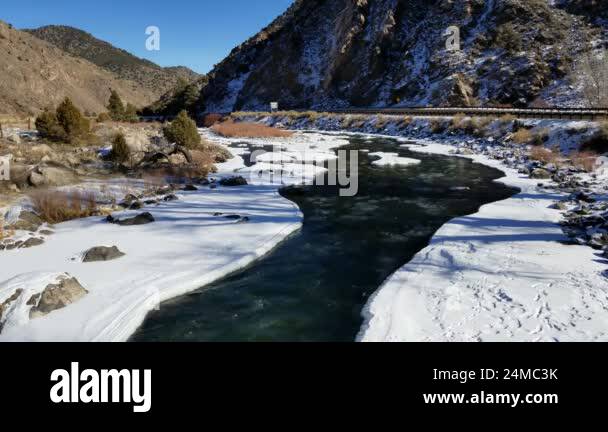 Footage of the partly frozen Arkansas River on a sunny winter day as it ...
