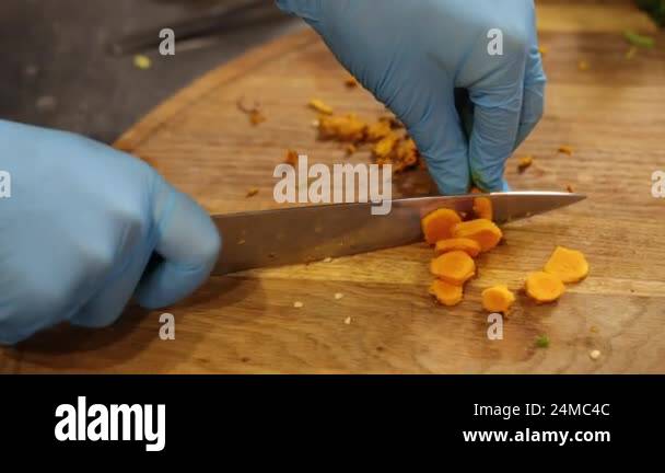 Chef hands, chopping knife, culinary skills. Close-up gloved hands ...