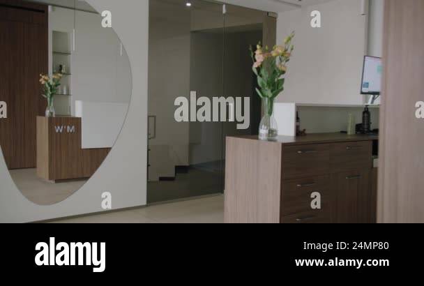 A sleek, contemporary reception desk in a corporate office featuring ...