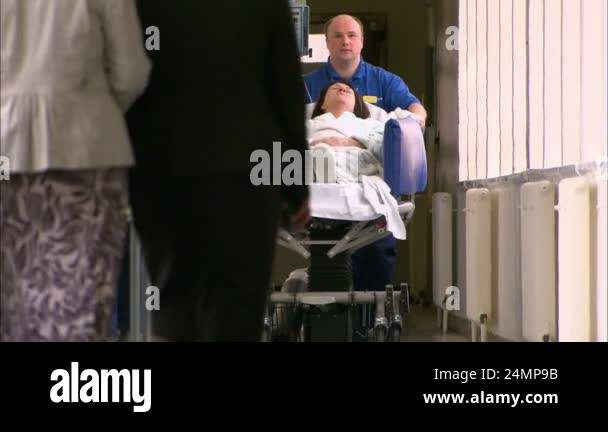 Porter moving patient bed in hospital corridor Stock Video Footage - Alamy