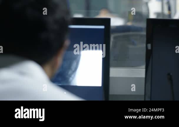 Patient undergoing X-ray fluoroscopy, as a radiologist monitors the ...