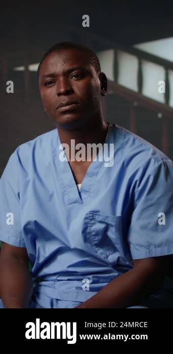 Vertical Video Black medical assistant being defocused and disconnected ...