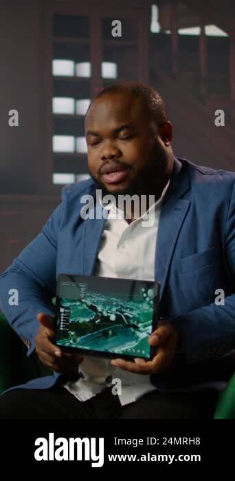 Vertical Video African american CIA expert monitoring reconnaissance ...