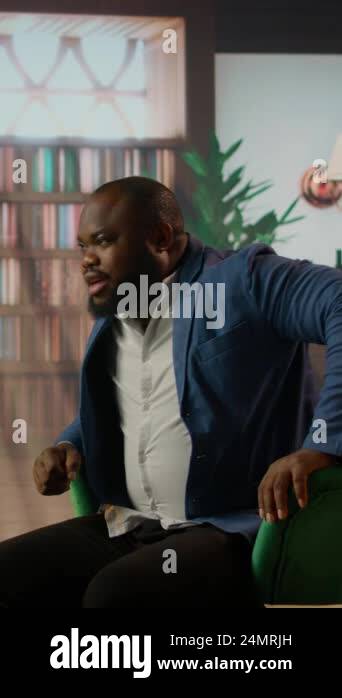 Vertical Video Billionaires engaged in an intense discussion sipping ...