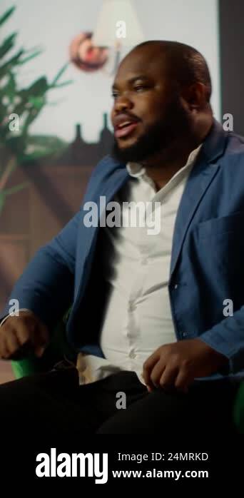 Vertical Video Billionaires engaged in an intense discussion sipping ...