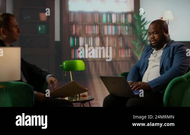 Diverse spies monitoring satellite surveillance data at headquarters ...