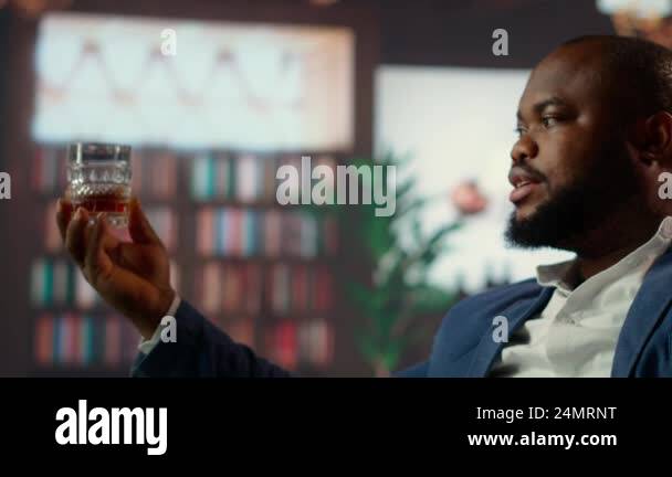 Multiethnic entrepreneurs talk business strategy over whiskey in a ...