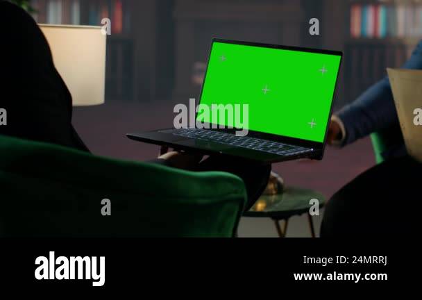 Two secret agents examine case details at CIA safe house with a mockup ...