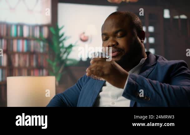 High society billionaire drinking whiskey at the classy luxurious ...