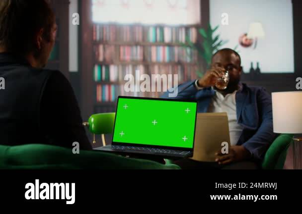 Two secret agents examine case details at CIA safe house with a mockup ...