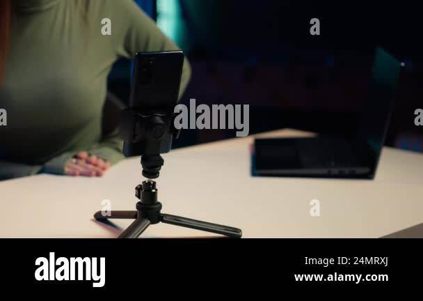 Focus on mobile phone used by influencer to film content for her online ...
