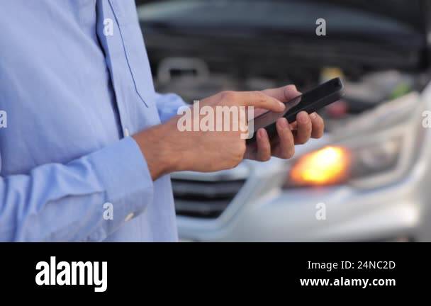 Unrecognizable man wearing blue shirt calling car repair service ...