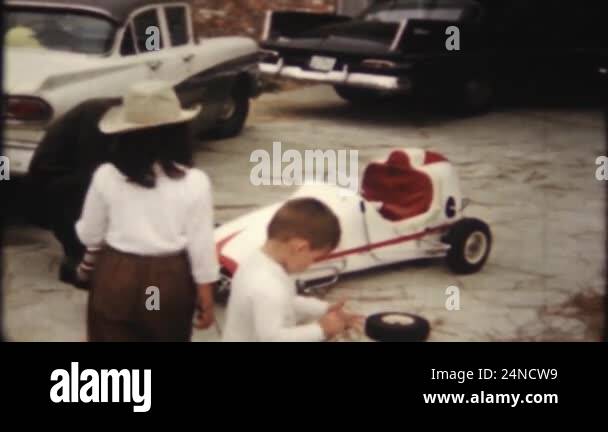 father and son work on the Soap Box Derby Car for upcoming race at home ...