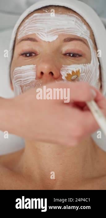 Applying anesthesia to a womans face in cosmetology. Anesthesia before ...