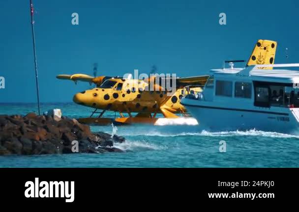 HURAA ISLAND, MALDIVES - OCTOBER 31, 2024 Yellow seaplane floats on the ...