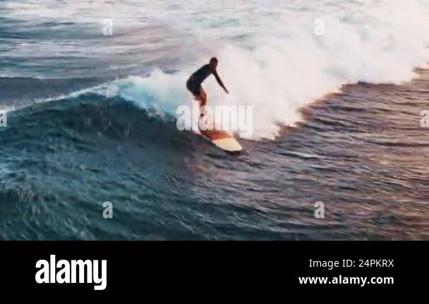 Wave surfing aerial. Man surfs the wave in the Maldives Stock Video ...
