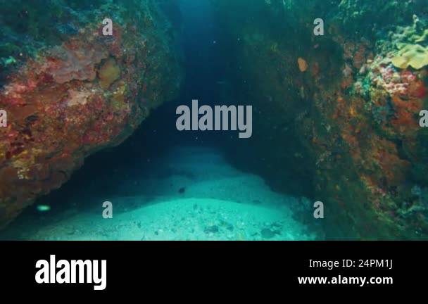 Light rays illuminating a narrow passage between two large rocks ...